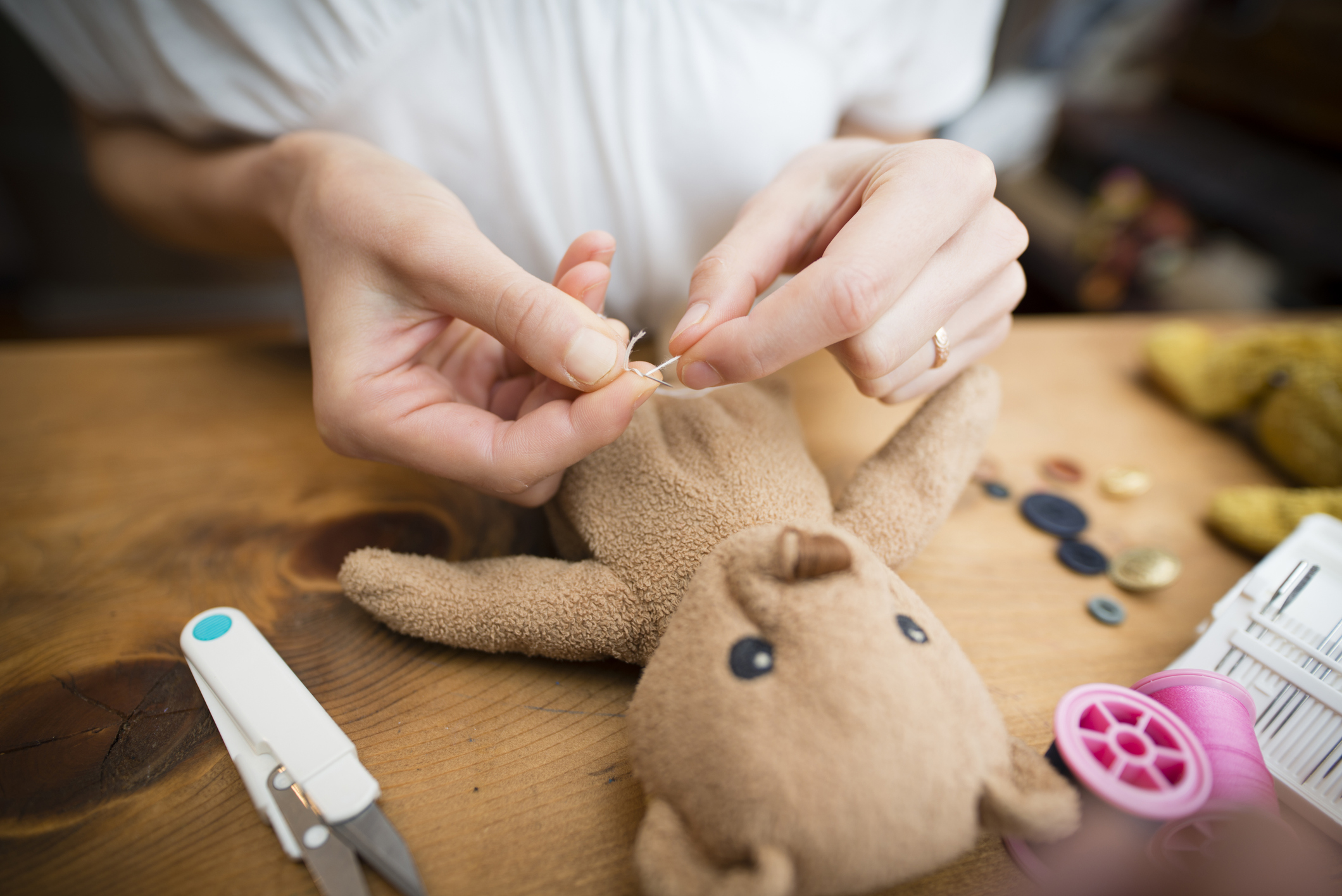 Hand to fix a stuffed toy bear - Fairfield World